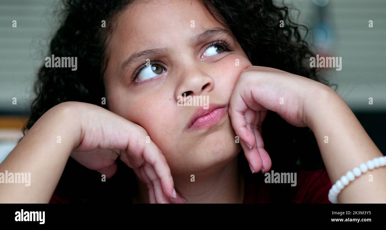 Thoughtful little girl thinking about solution to problem. Pensive ...