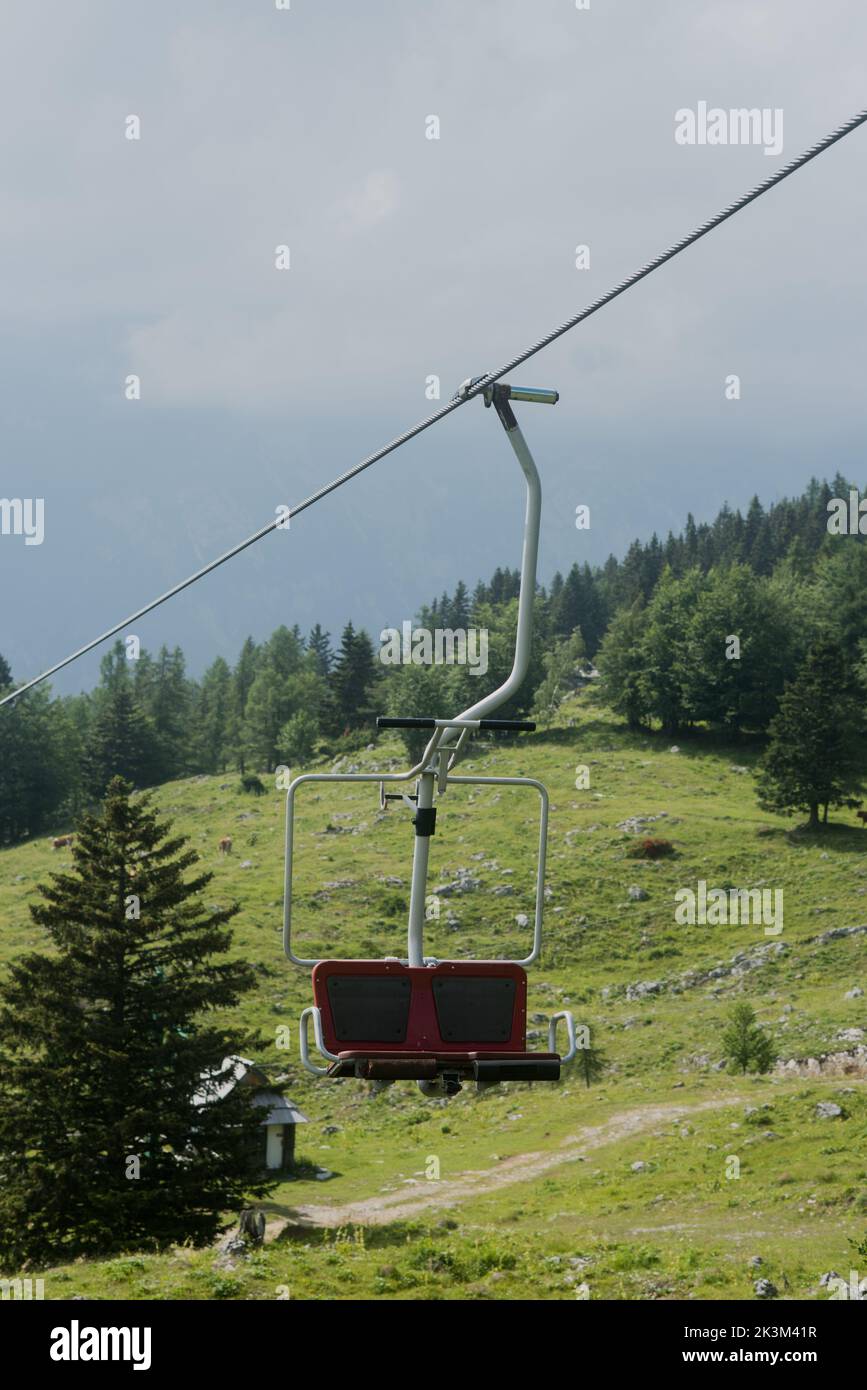 A beautiful shot of a cableway lift surrounded by the mountainous ...
