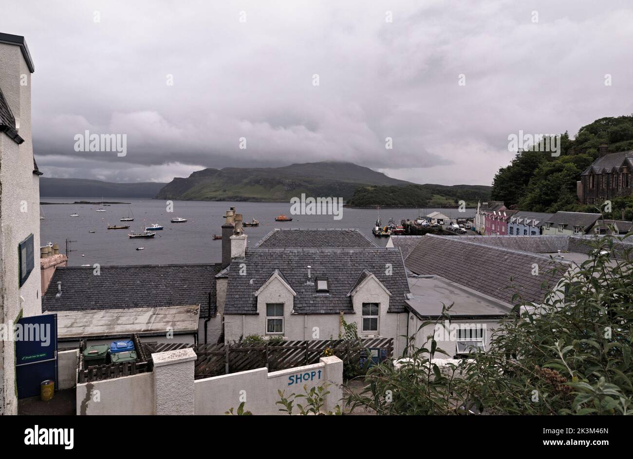 Fishing boats in Portree harbour, Loch Portree and Ben Tianavaig in ... Fishing boats in Portree harbour, Loch Portree and Ben Tianavaig in ...