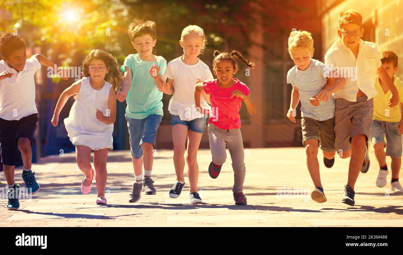 Happy kids running in race in the street and laughing outdoors Stock ...