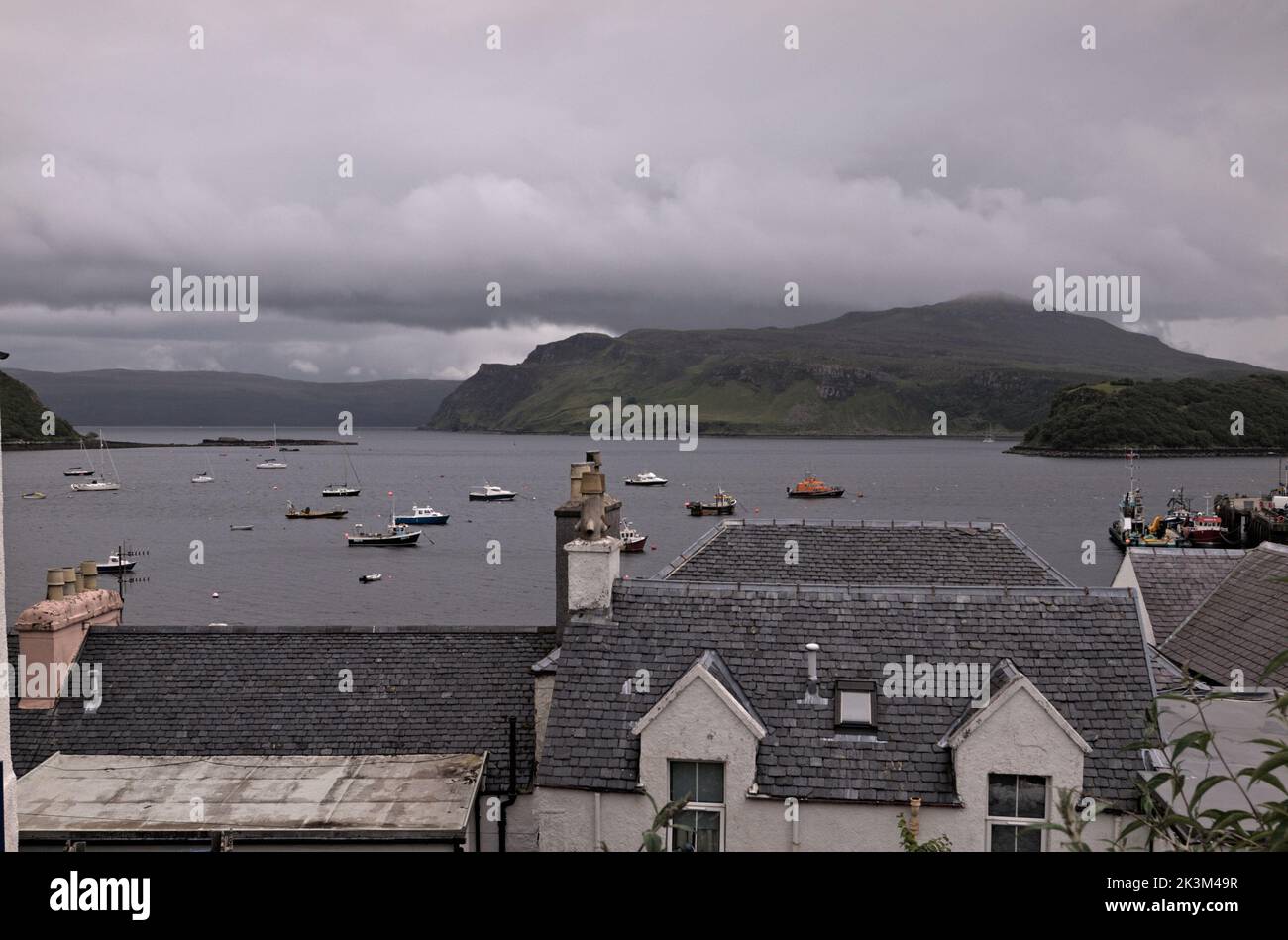 Fishing boats in Portree harbour, Loch Portree and Ben Tianavaig in ... Fishing boats in Portree harbour, Loch Portree and Ben Tianavaig in ...
