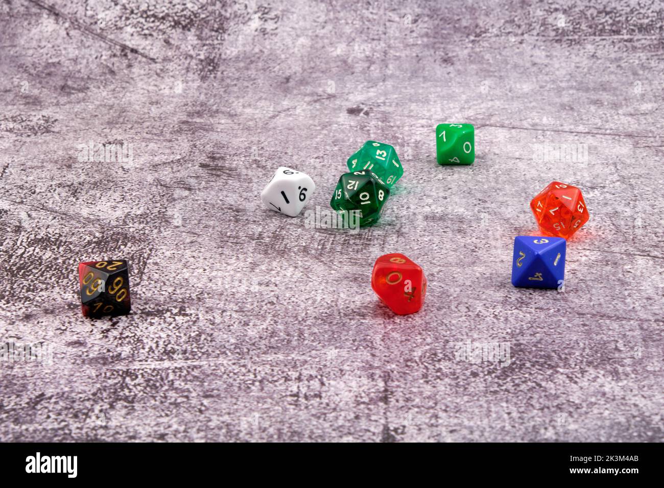 Different colored dice on an abstract cement-like background Stock ...