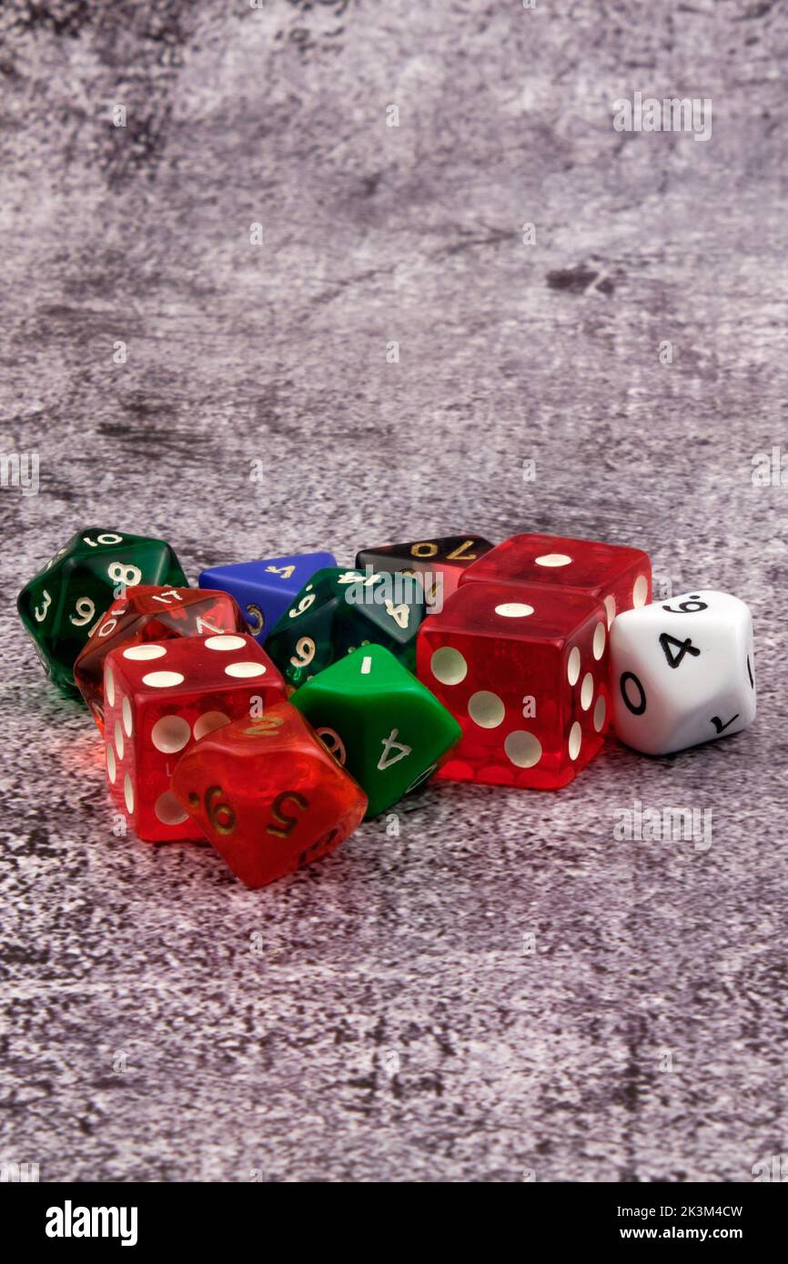 Different colored dice on an abstract cement-like background Stock ...