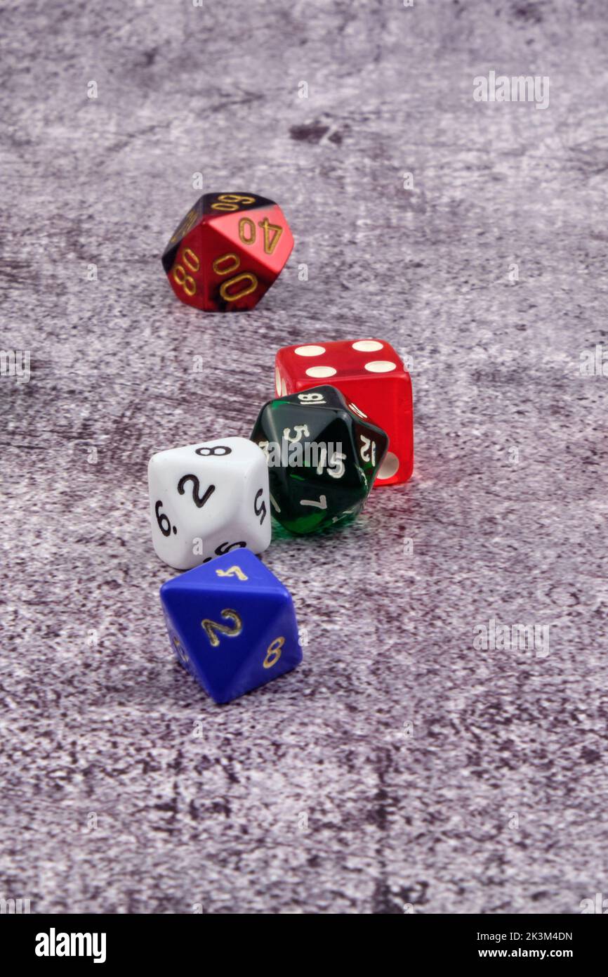 Different colored dice on an abstract cement-like background Stock ...