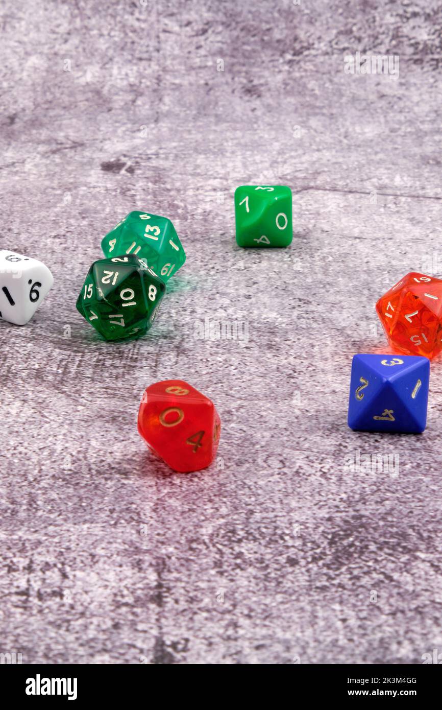 Different colored dice on an abstract cement-like background Stock ...