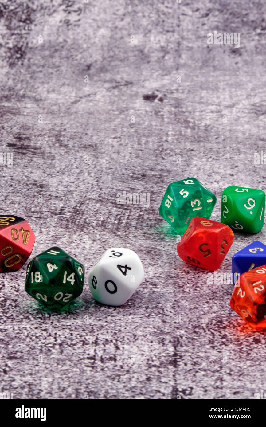 Different colored dice on an abstract cement-like background Stock ...