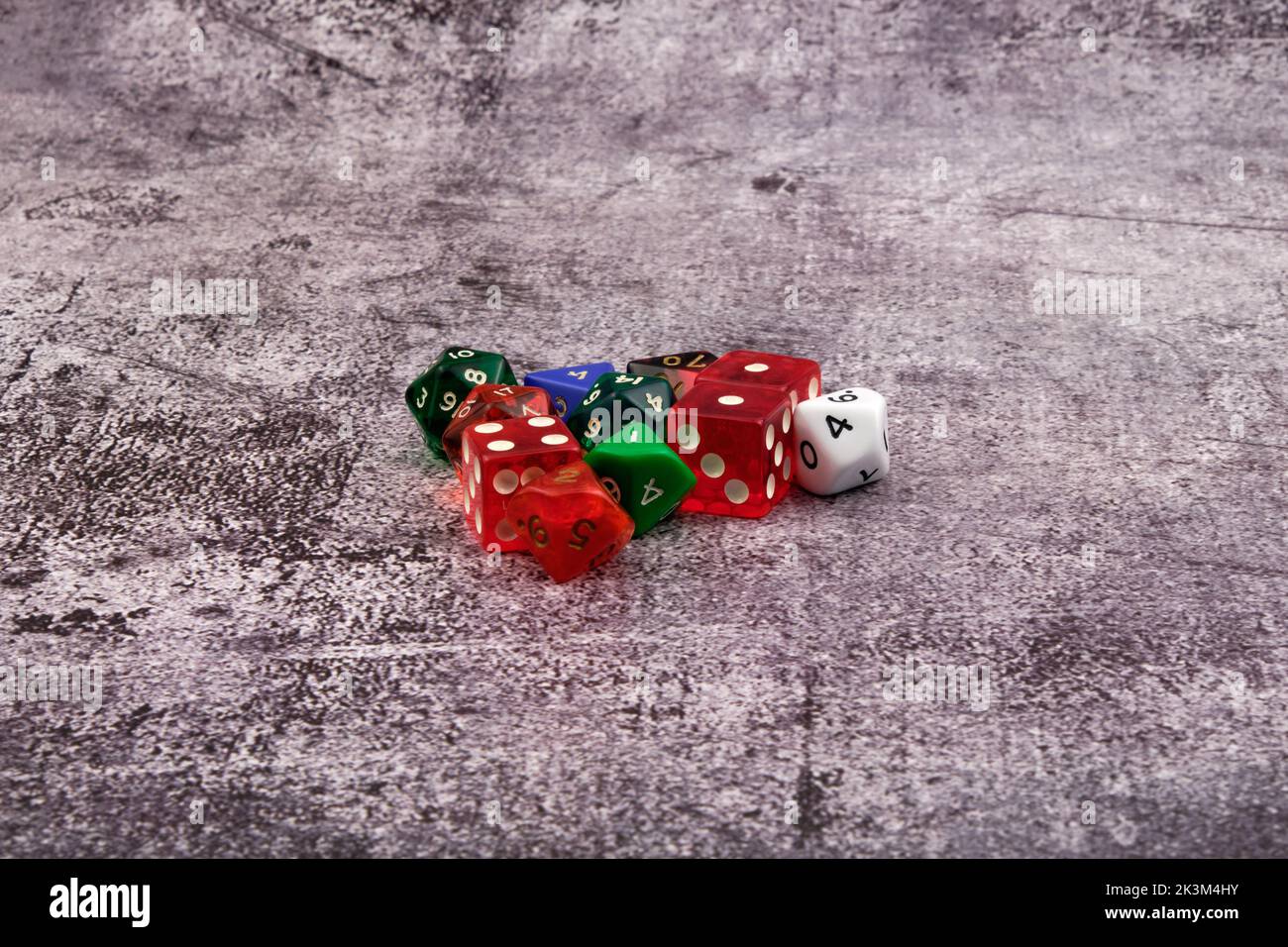 Different colored dice on an abstract cement-like background Stock ...