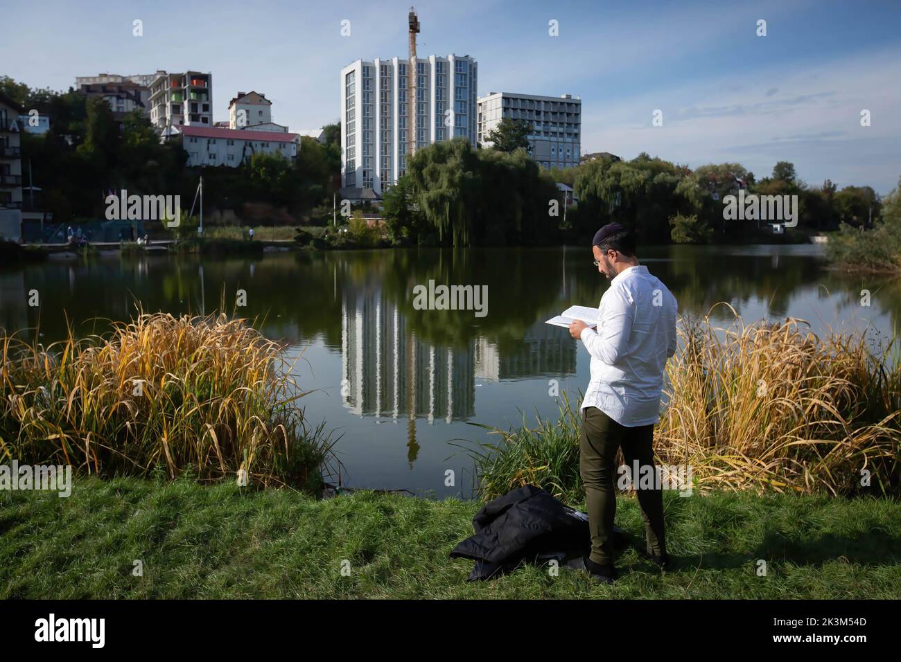 Ultra-Orthodox Jewish pilgrim prays next to the river of Umanka near ...