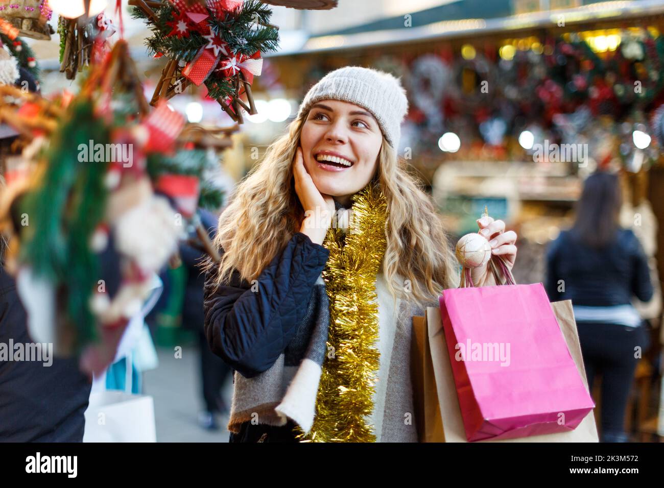 Cheerful girl near Christmas fair shops Stock Photo - Alamy