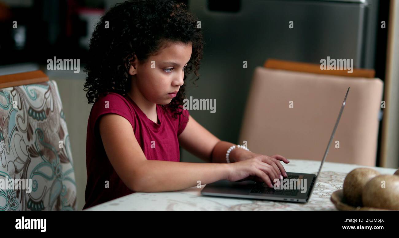 Little girl child using laptop computer at home. Candid kid browsing ...