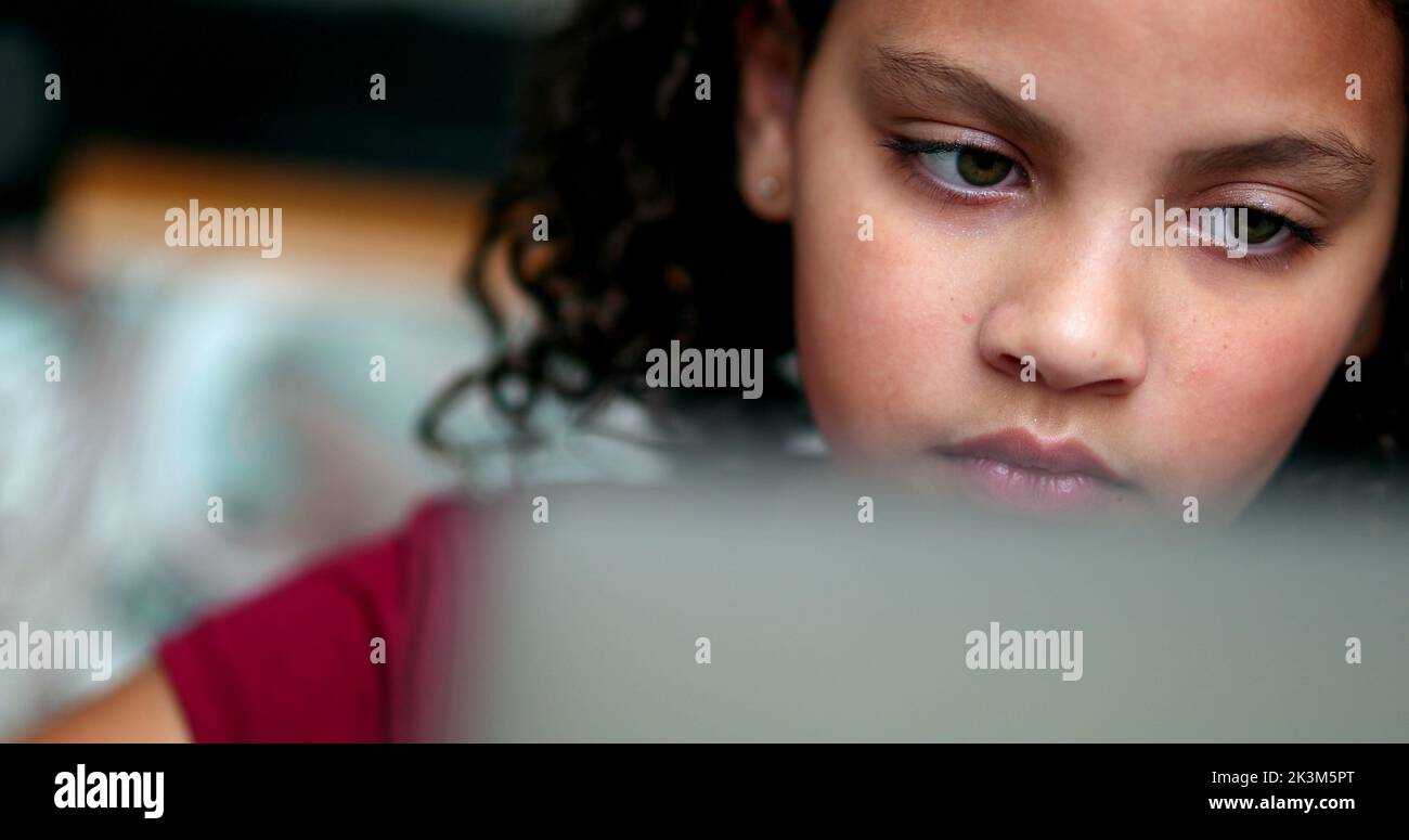 Little girl staring at computer screen, kid close-up face Stock Photo ...