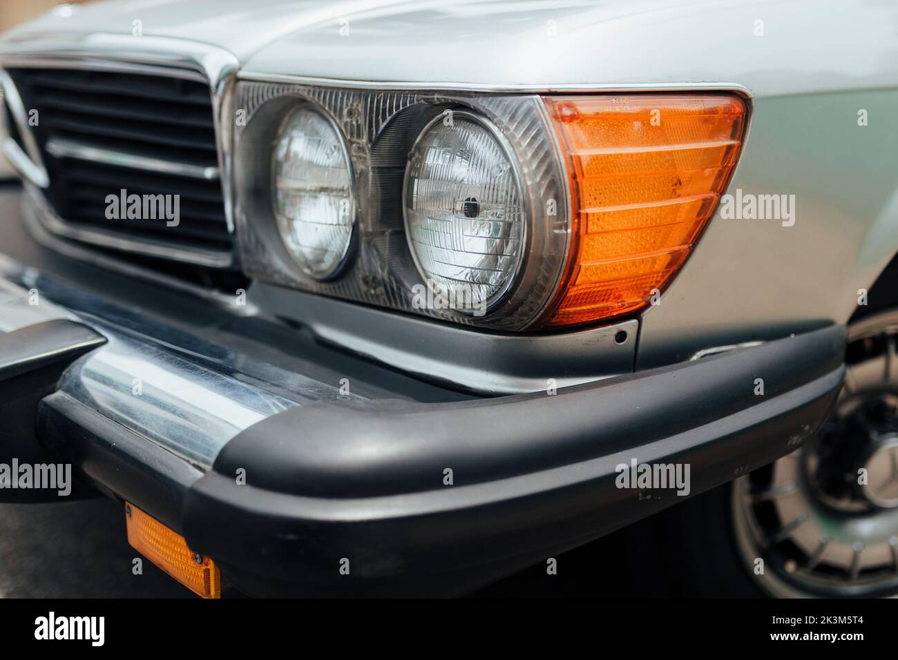 A beautiful shot of a front bumper and headlights of a vintage Mercedes ...