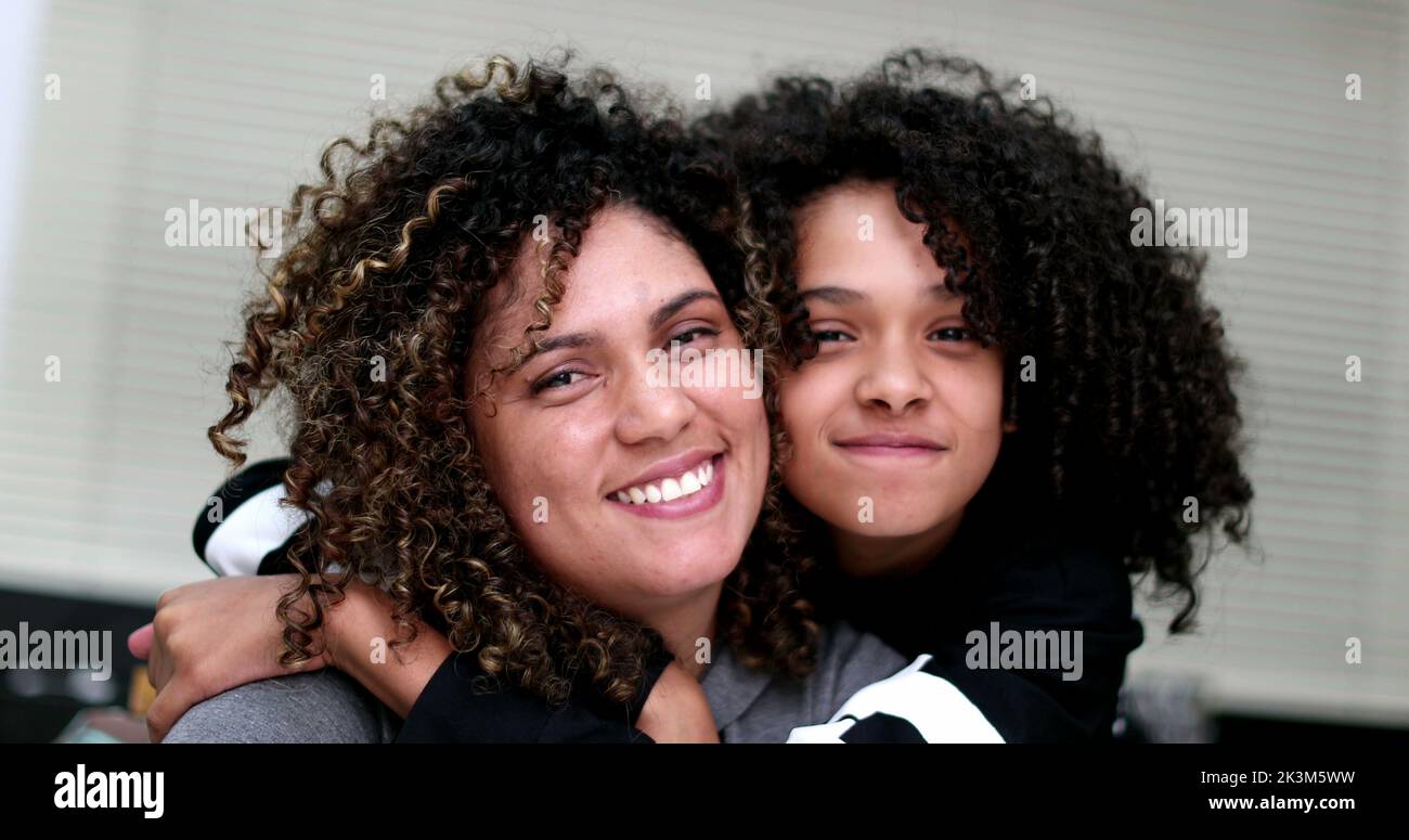 Mother and daughter spontaneous love and hug. Child and parent portrait ...