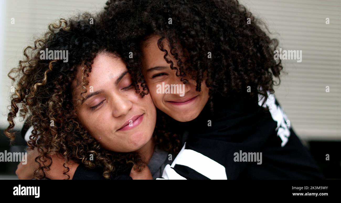 Mother and daughter spontaneous love and hug. Child and parent portrait ...