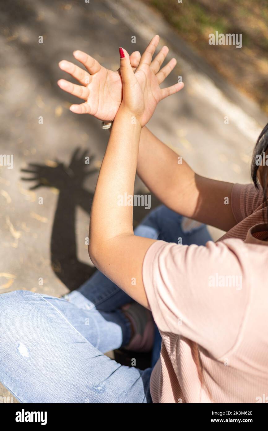 playing to make figures with the shadow of their hands, parts of the ...