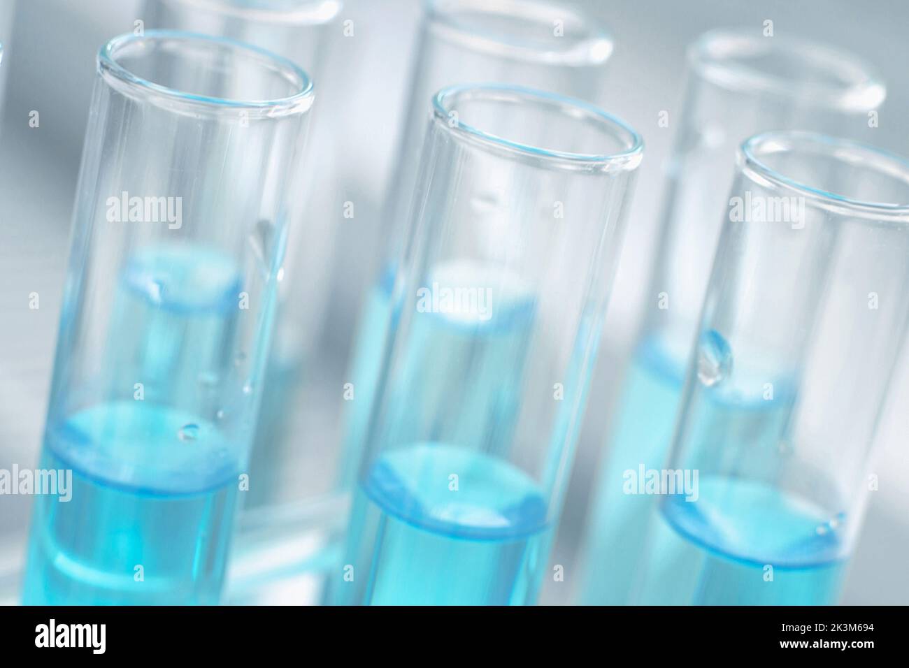 Laboratory test tubes with blue liquid close up, selective focus ...