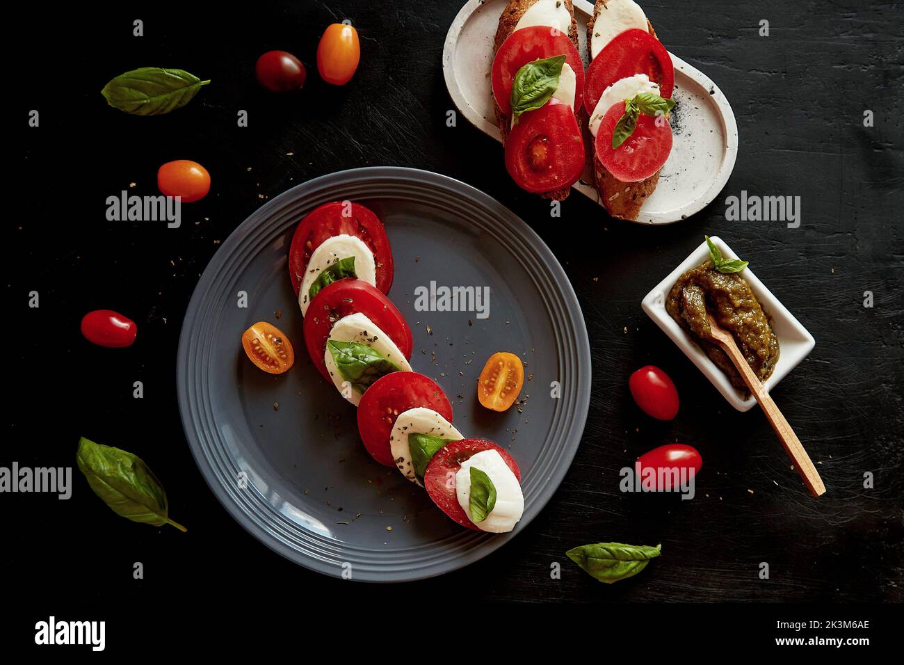 Italian caprese salad with fresh mozzarella, tomatoes, basil and pesto ...