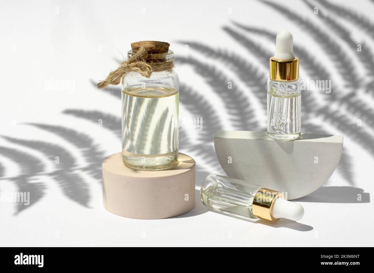 Natural oils in transparent bottles on a white background with ...