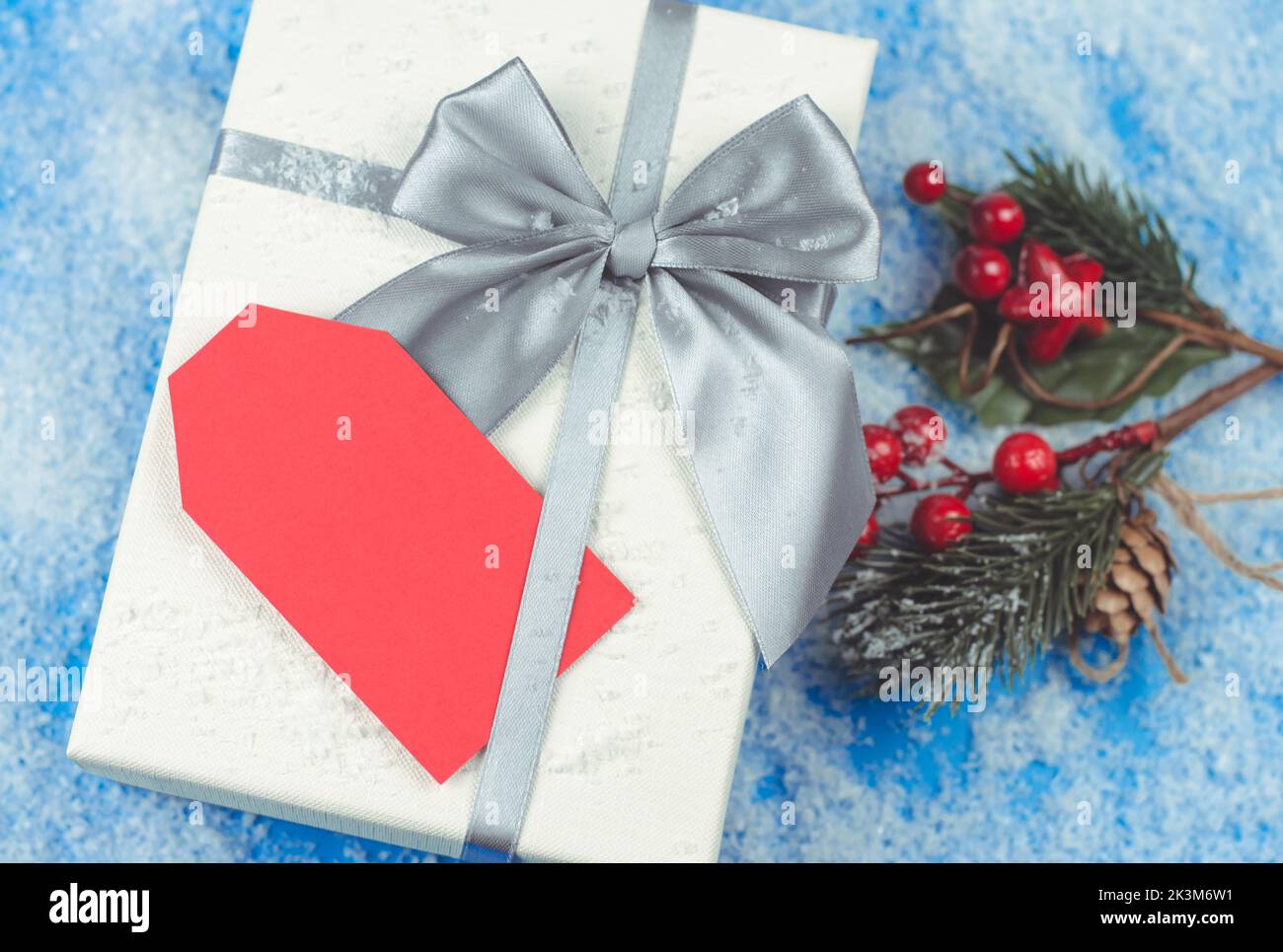 Blank red label on a white gift box. Mock up for Christmas greetings or ...