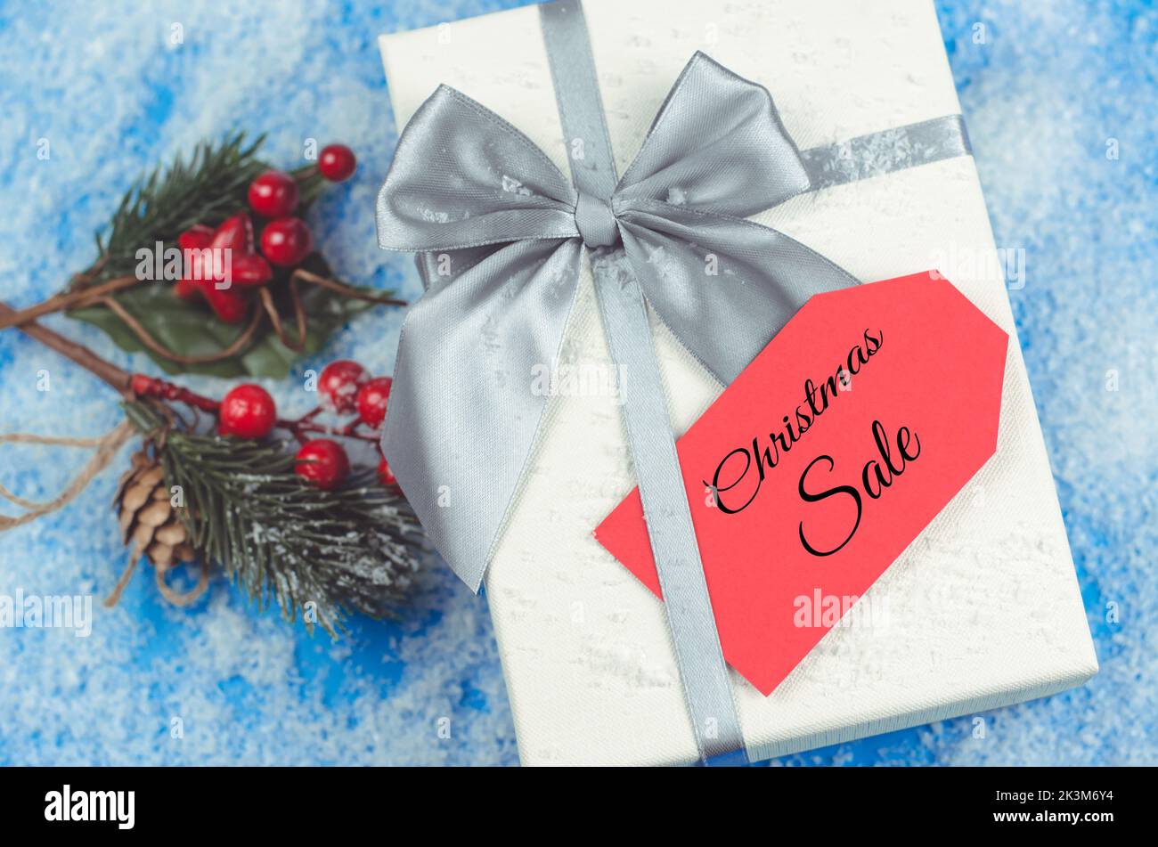 Red label on a gift box with the words Christmas Sale Stock Photo - Alamy