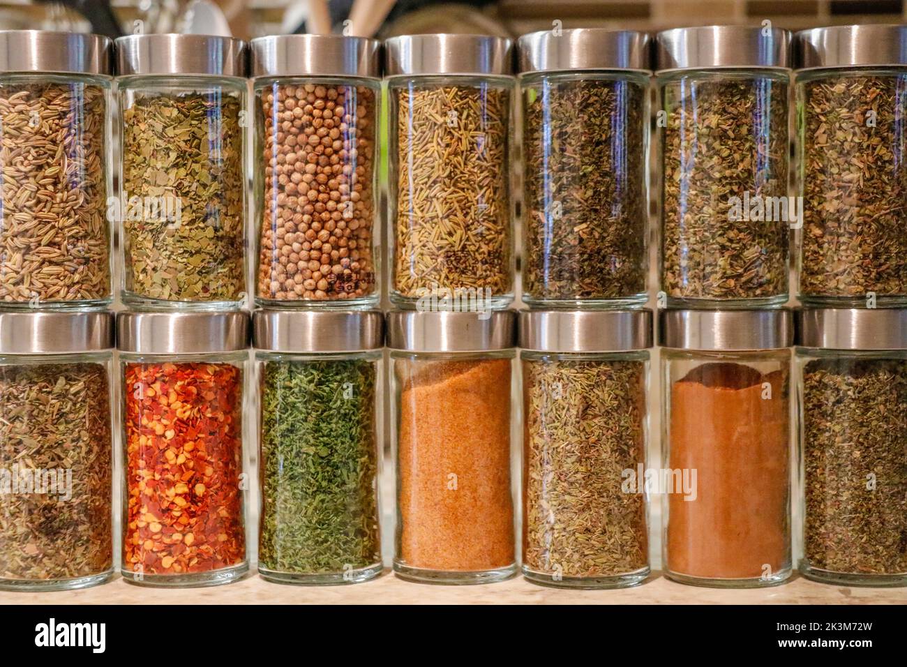 The rows of colorful spice jars neatly organized in a pantry Stock ...