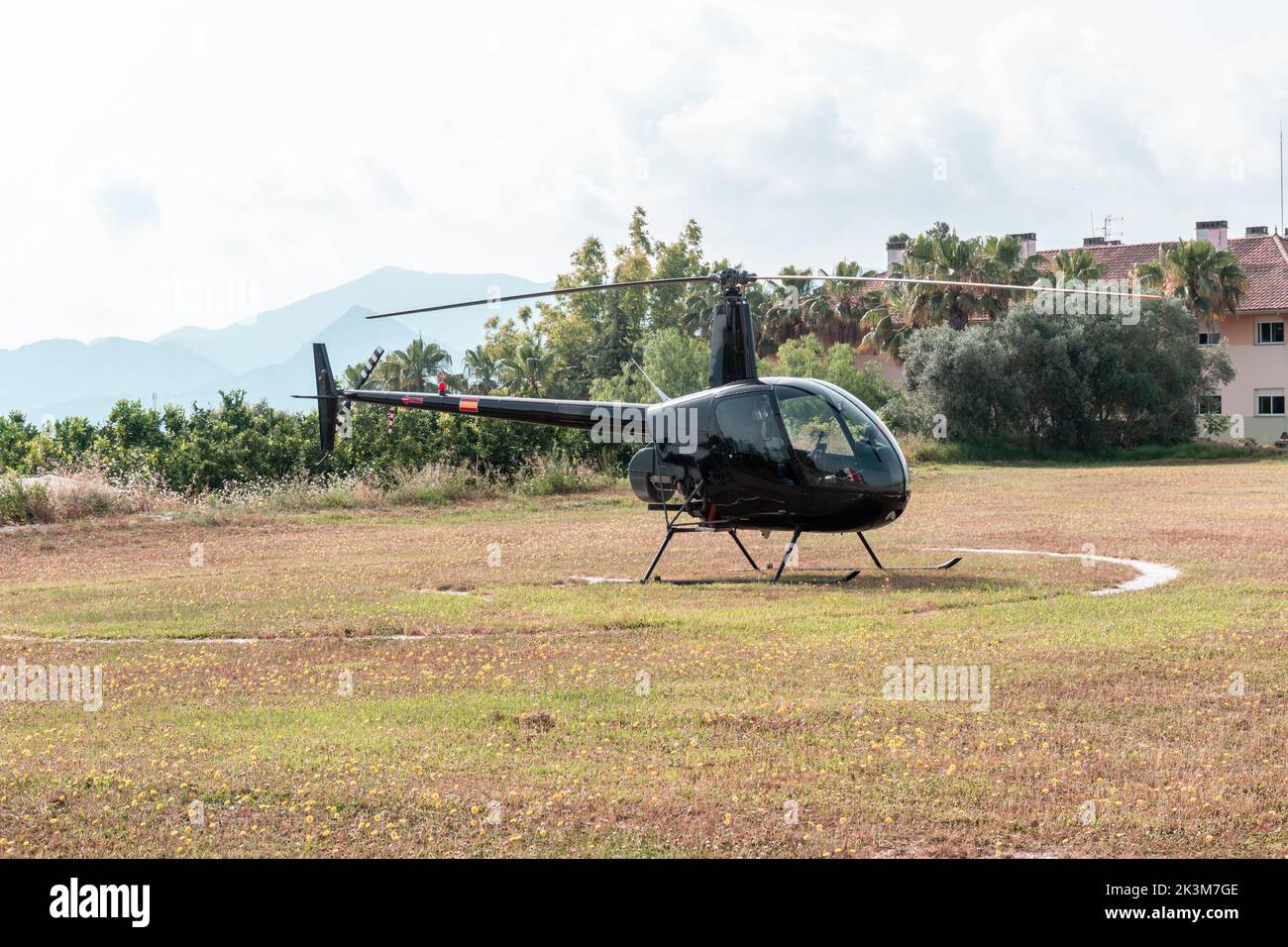 A helicopter parking in greenery field Stock Photo - Alamy