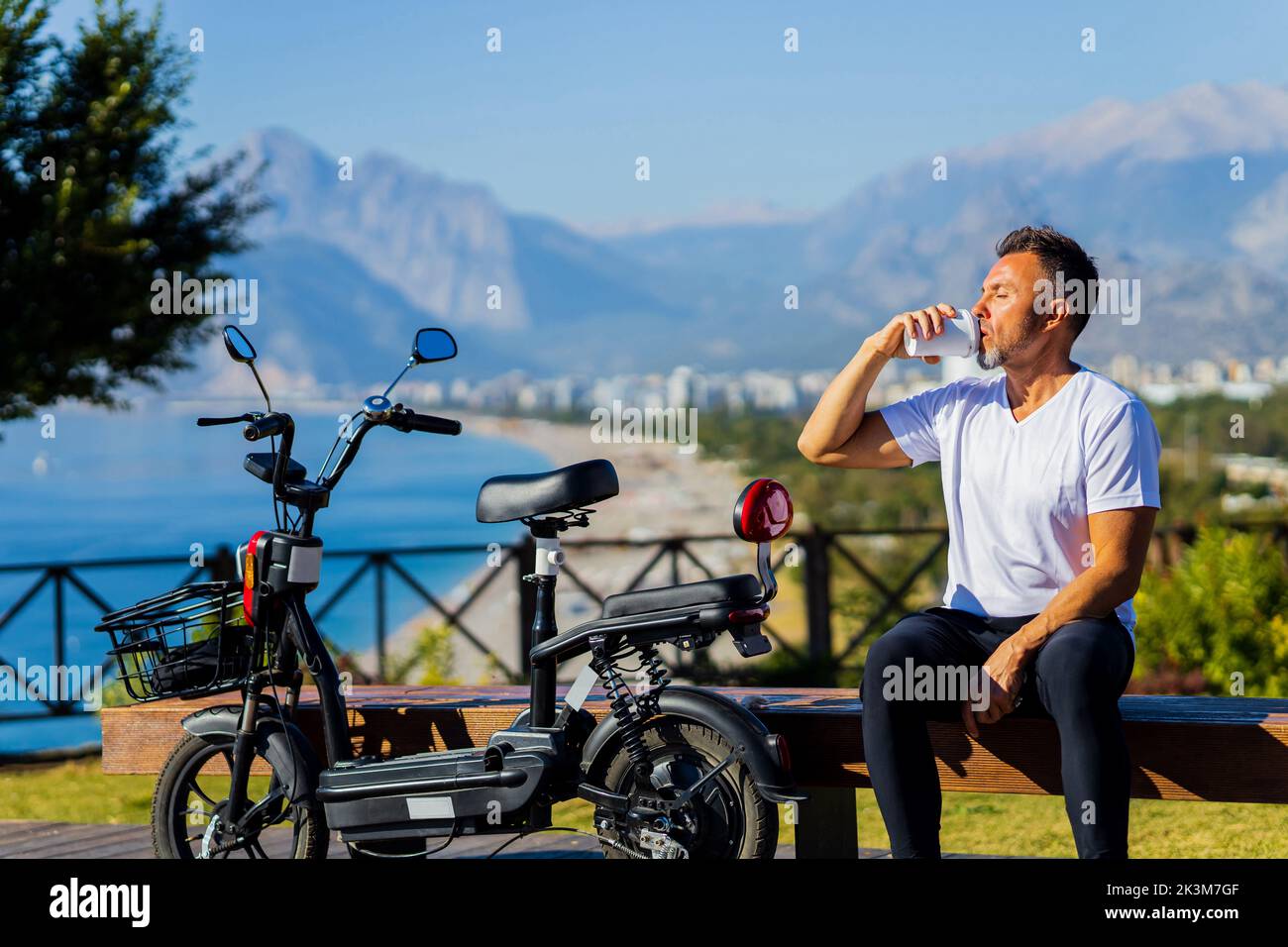 old-aged man good loking outdoors with eco scooter enjoying morning and ...