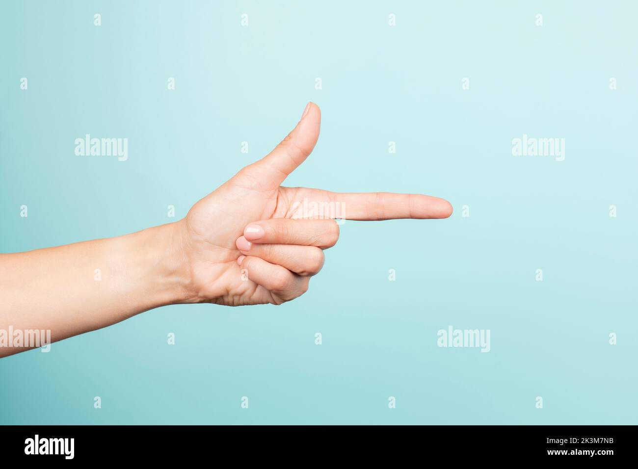 Woman hand pointing gesture. Female hand points finger at something on ...