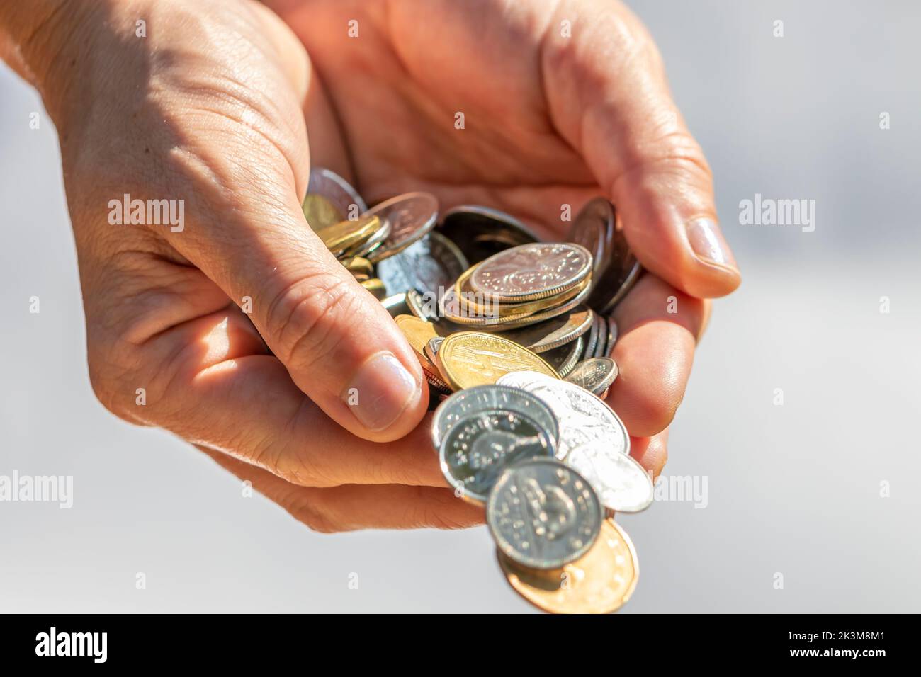 Hands dropping coins hi-res stock photography and images - Alamy