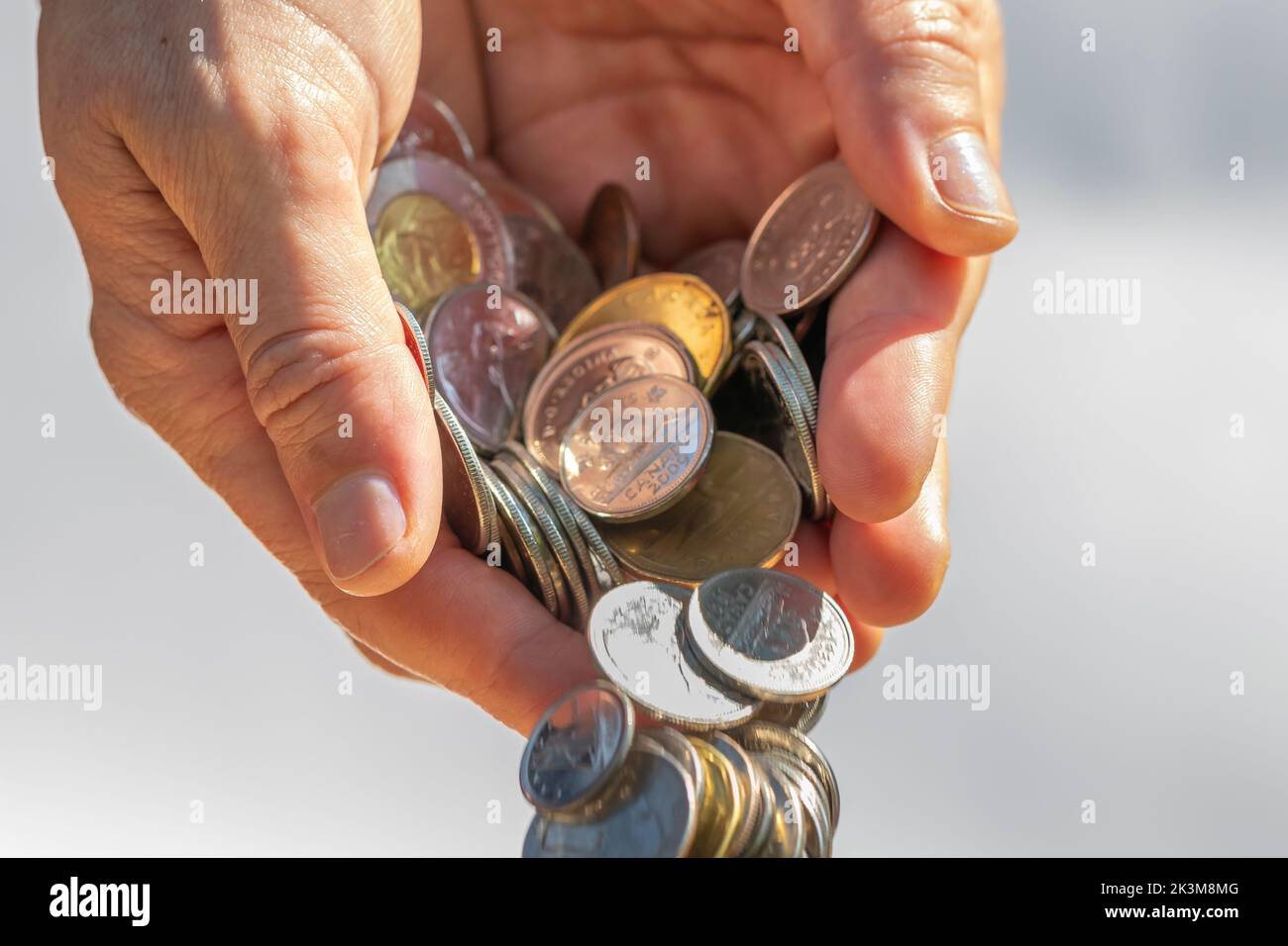 Hands dropping coins hi-res stock photography and images - Alamy