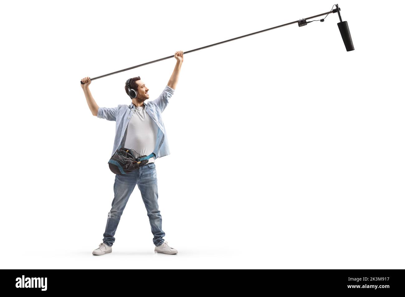 Full length shot of sound engineer holding a microphone on stage ...