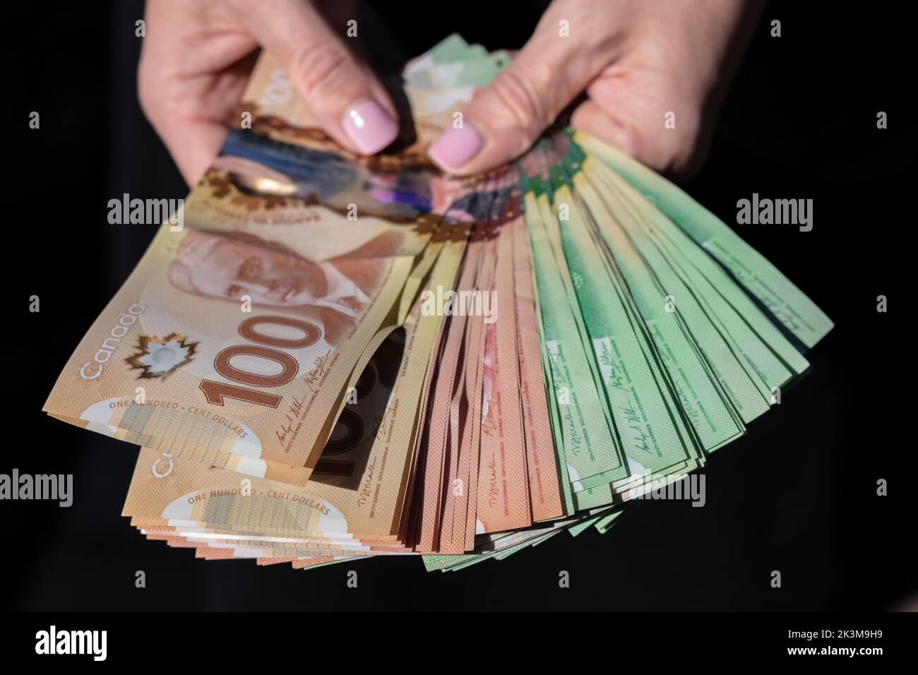 The closeup of Canadian cash in the hands Stock Photo - Alamy