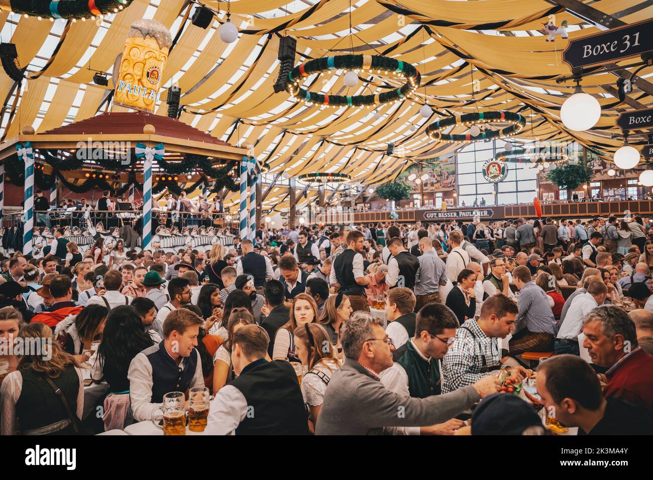 People sitting in beer tent at Oktoberfest Munich. Celebrating cheerful ...