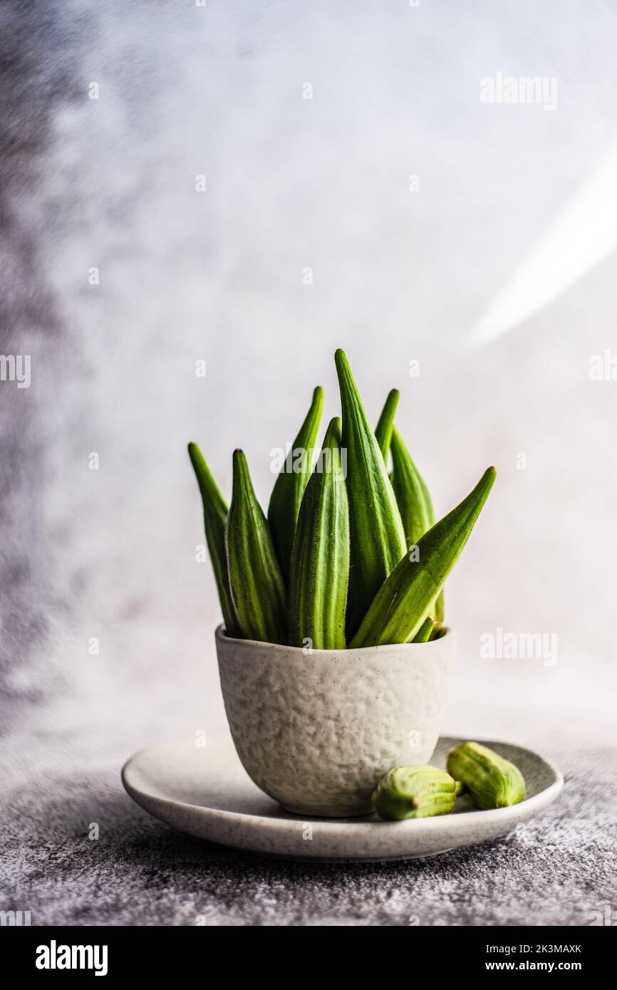 Bowls of bamia vegetable on concrete background Stock Photo - Alamy
