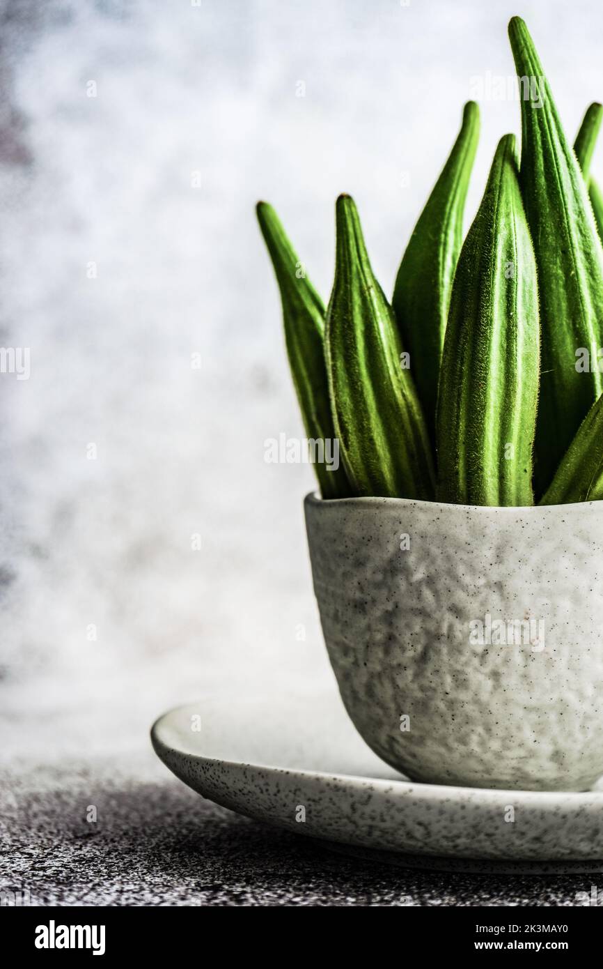 Bowls of bamia vegetable on concrete background Stock Photo - Alamy