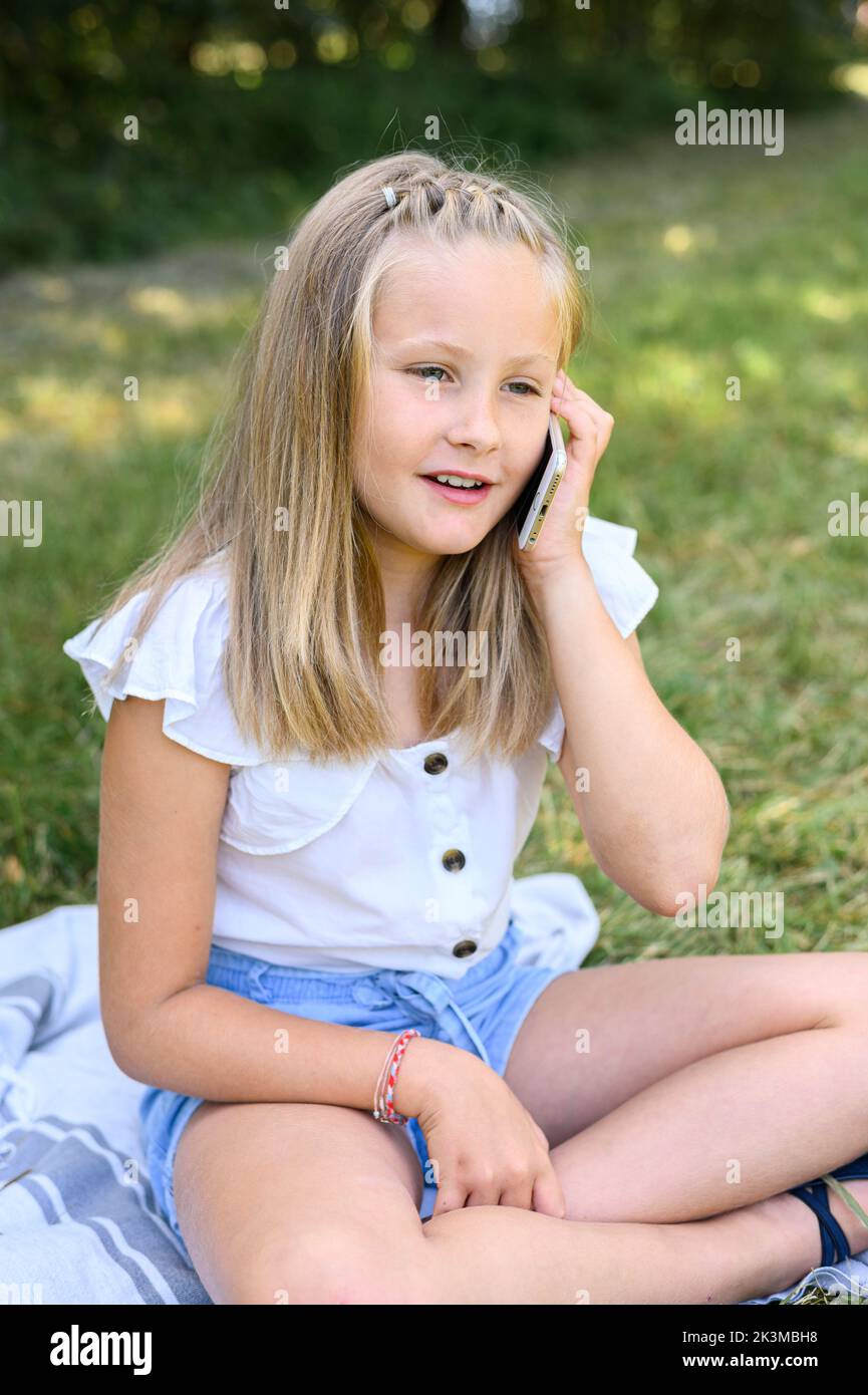 Little blond girl sitting crossed hi-res stock photography and images ...