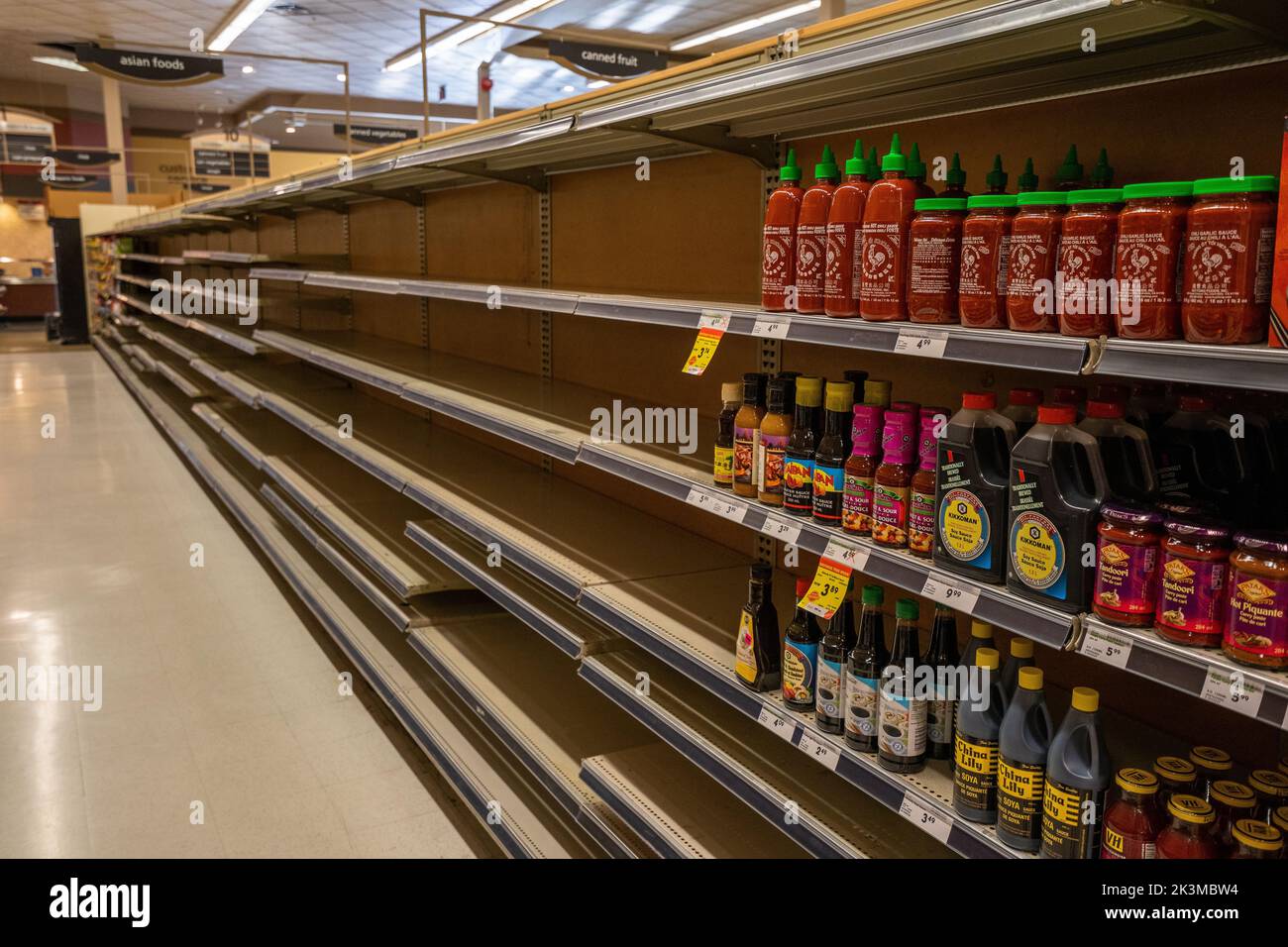 The empty grocery store shelves with many products missing Stock Photo ...