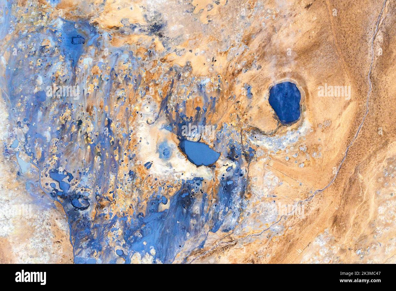 Aerial top view of blue mud bubbling in rough crater in Hverir ...