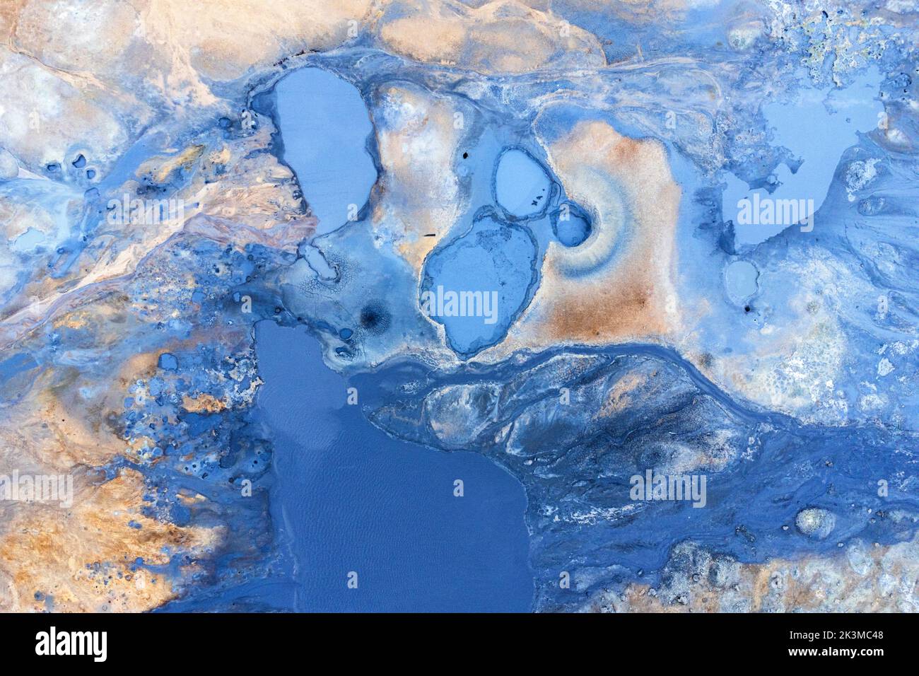 Aerial top view of blue mud bubbling in rough crater in Hverir ...