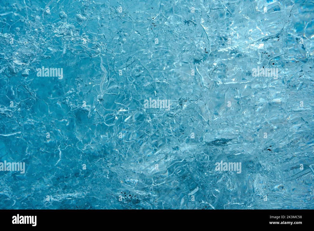 Clean blue water rippling near ice formations of glacier in Vatnajokull ...