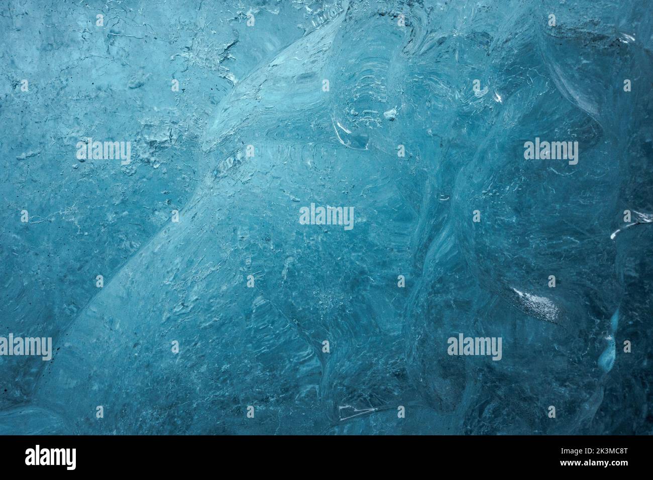 Clean blue water rippling near ice formations of glacier in Vatnajokull ...