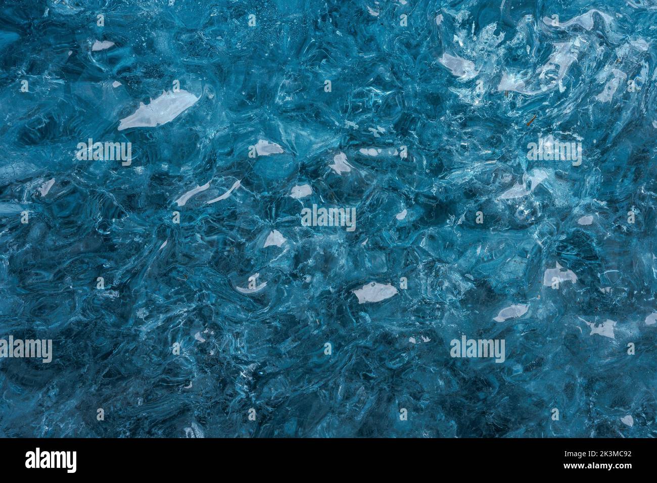 Clean blue water rippling near ice formations of glacier in Vatnajokull ...