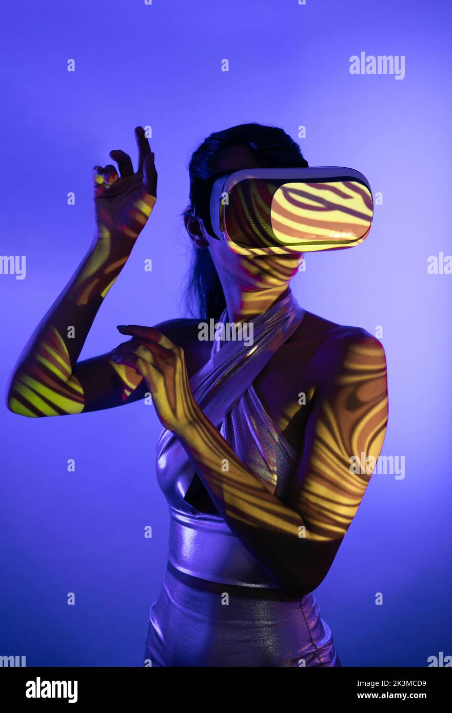 Unrecognizable young woman with long dark hair in futuristic outfit and ...