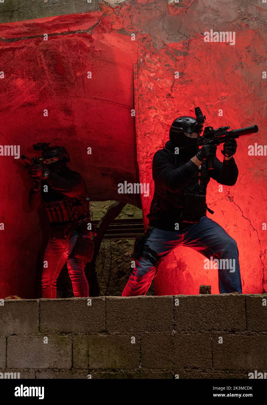 Anonymous male squad fighters in protective outfit helmets and masks ...