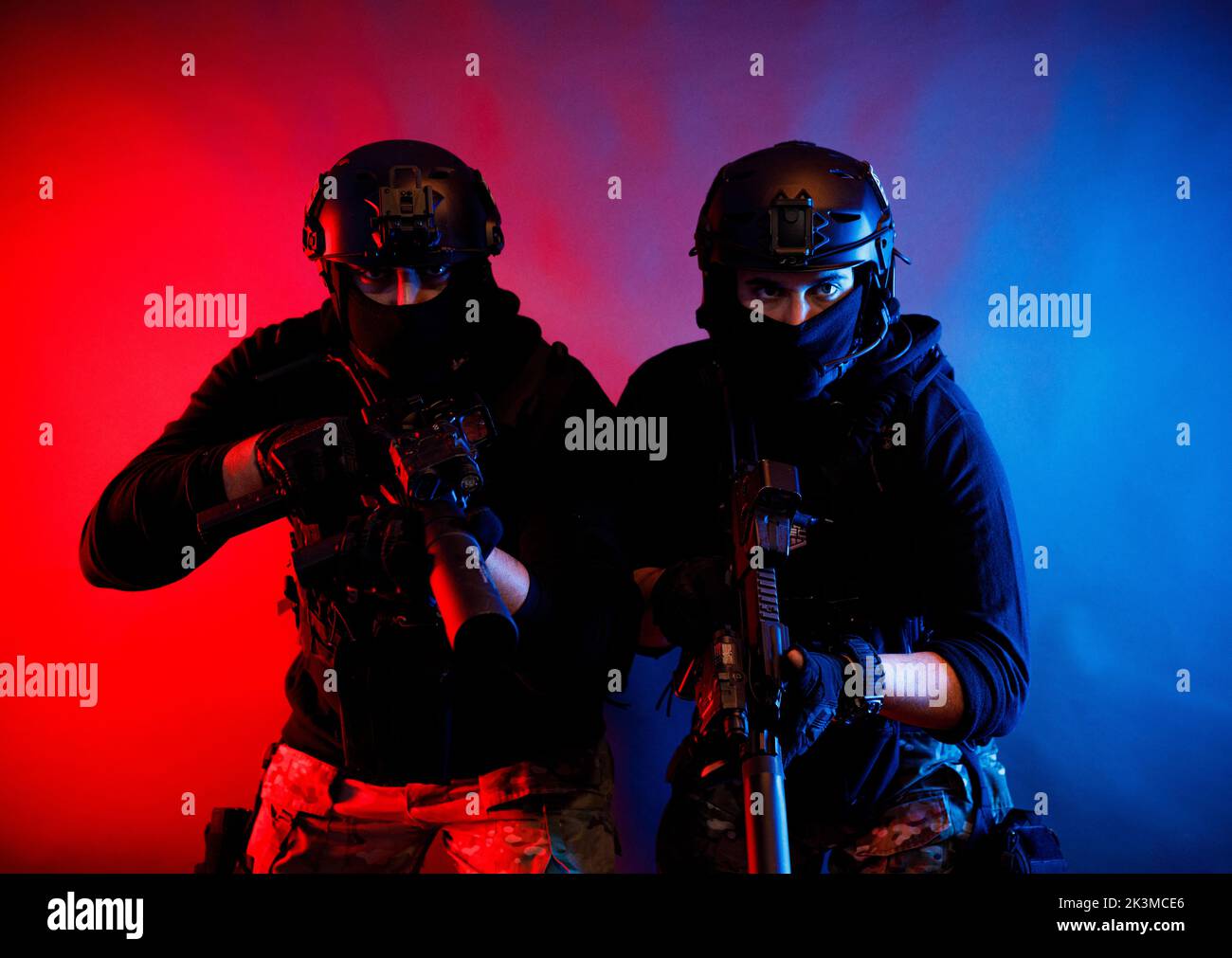 Unrecognizable concentrated male squad fighter in black protective gear ...