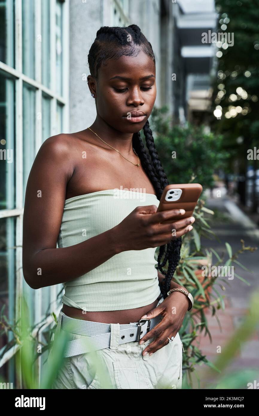 Young African American woman with long braids wearing stylish tube top ...