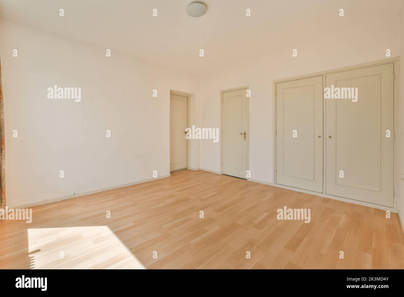 Interior of spacious empty old room with laminated floor and wardrobe ...
