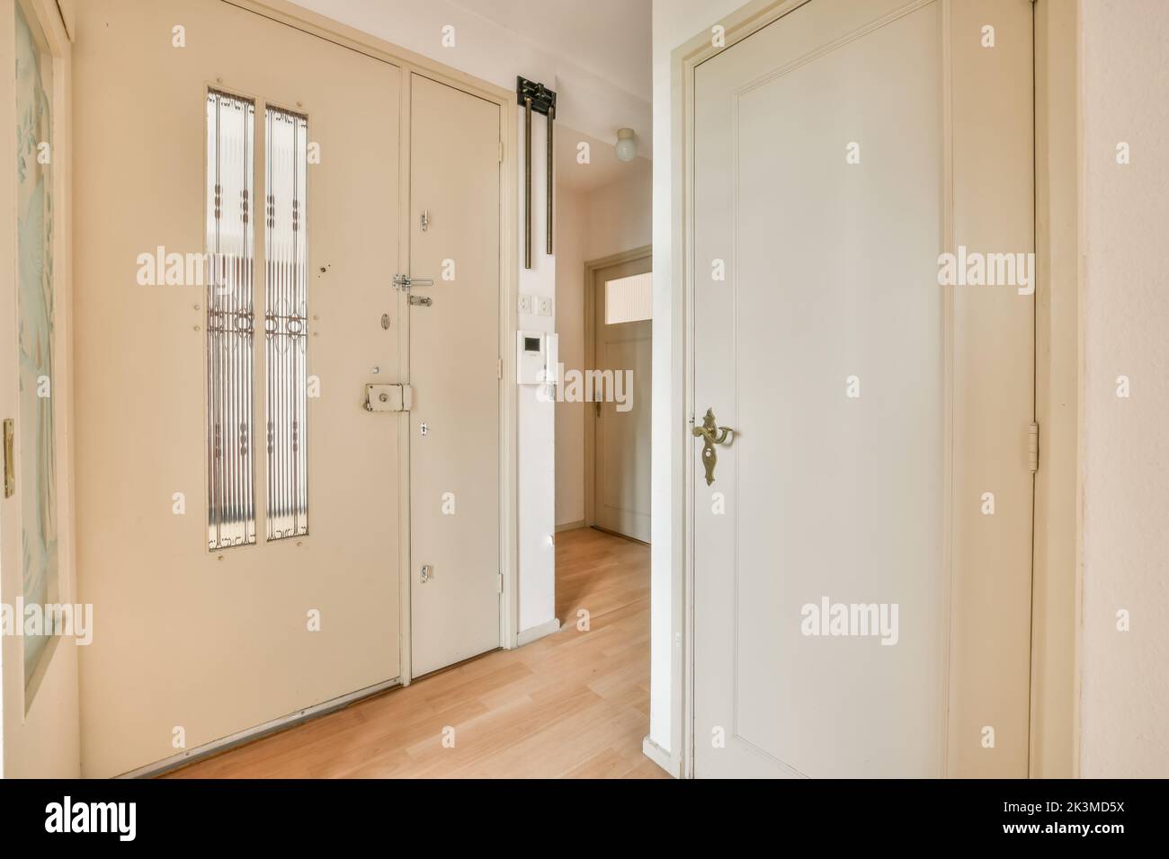 interior of light narrow hallway in empty home with parquet floor and ...