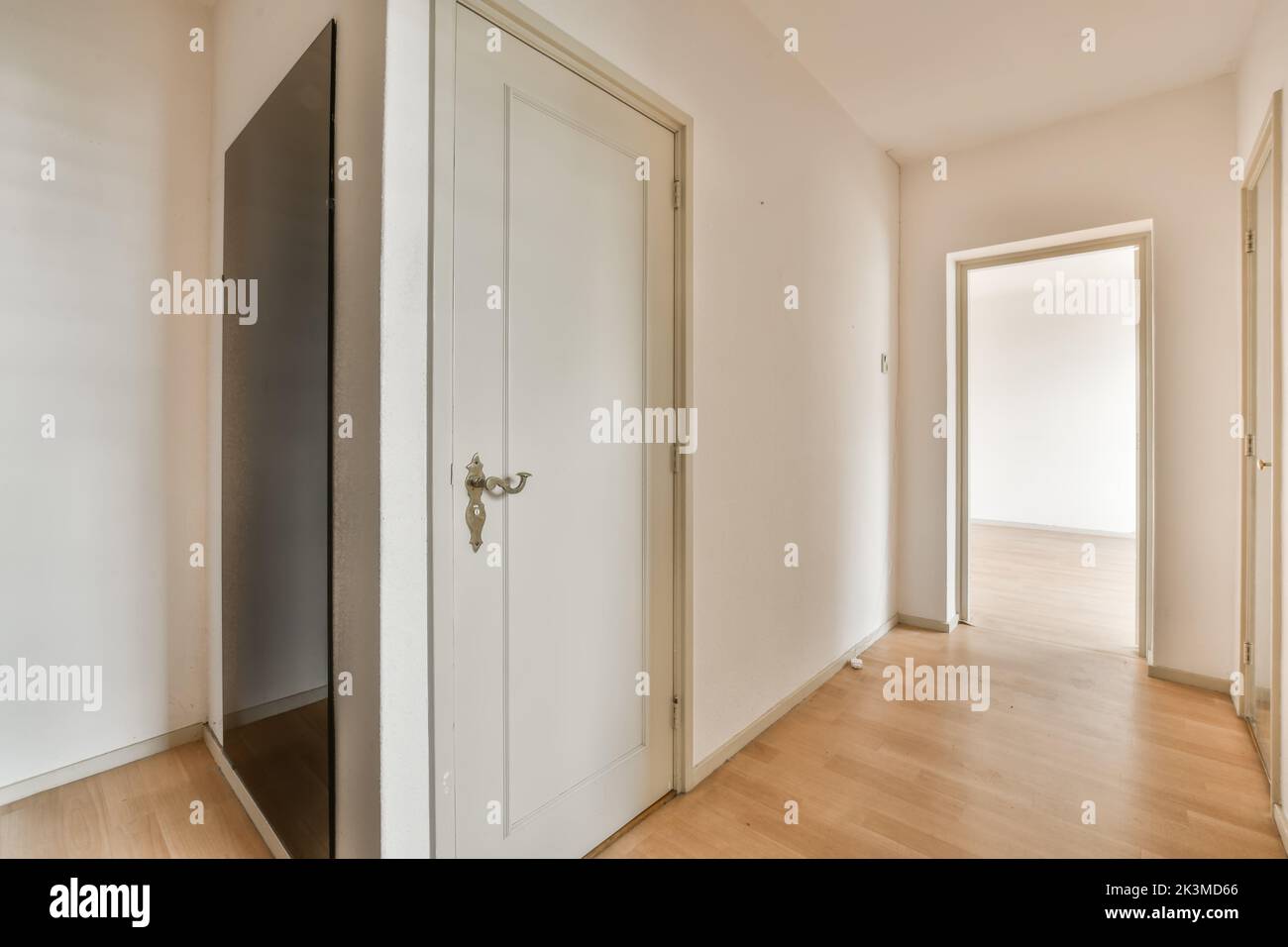 interior of light narrow hallway in empty home with parquet floor and ...