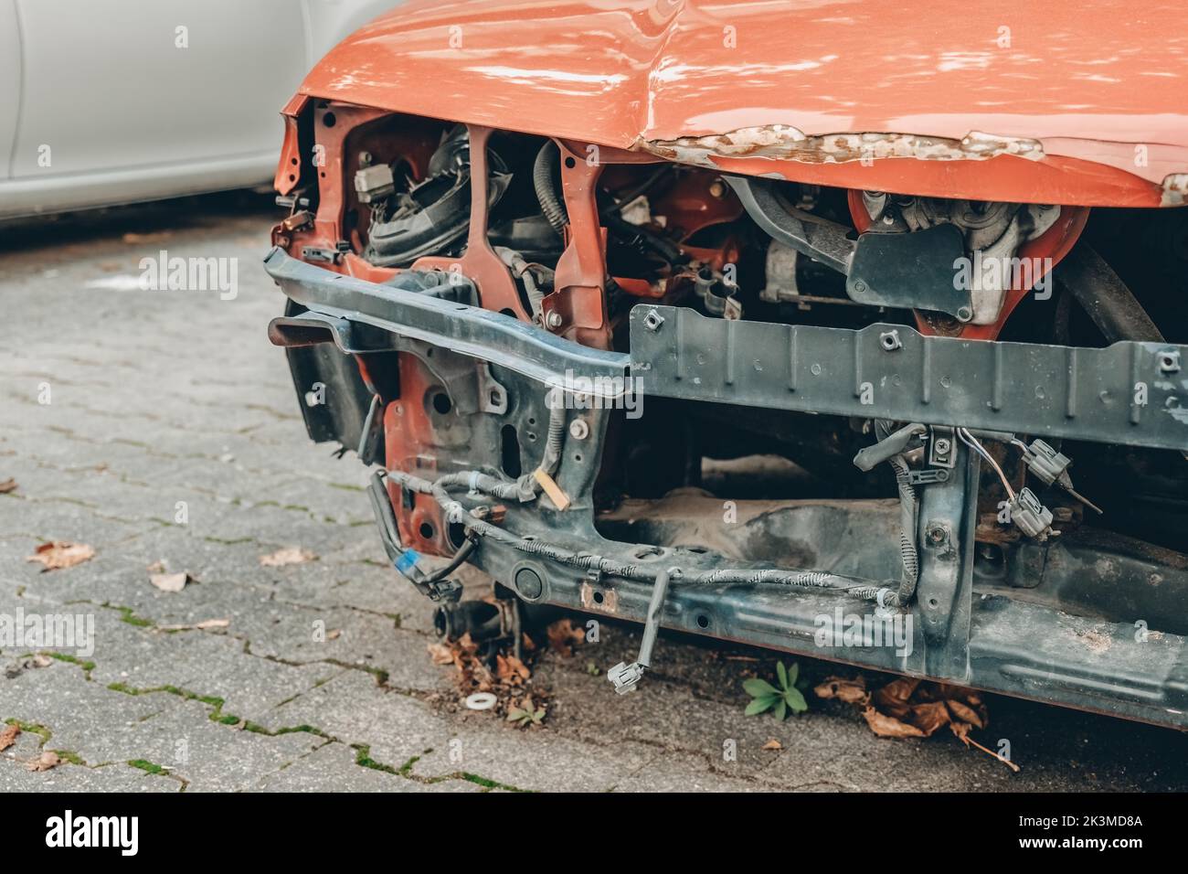a destroyed red car wreck in a parking lot Stock Photo - Alamy